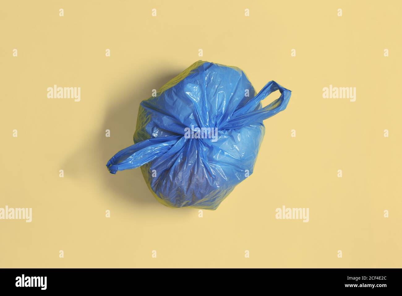 garbage bag tied with a knot on soft color background Stock Photo - Alamy