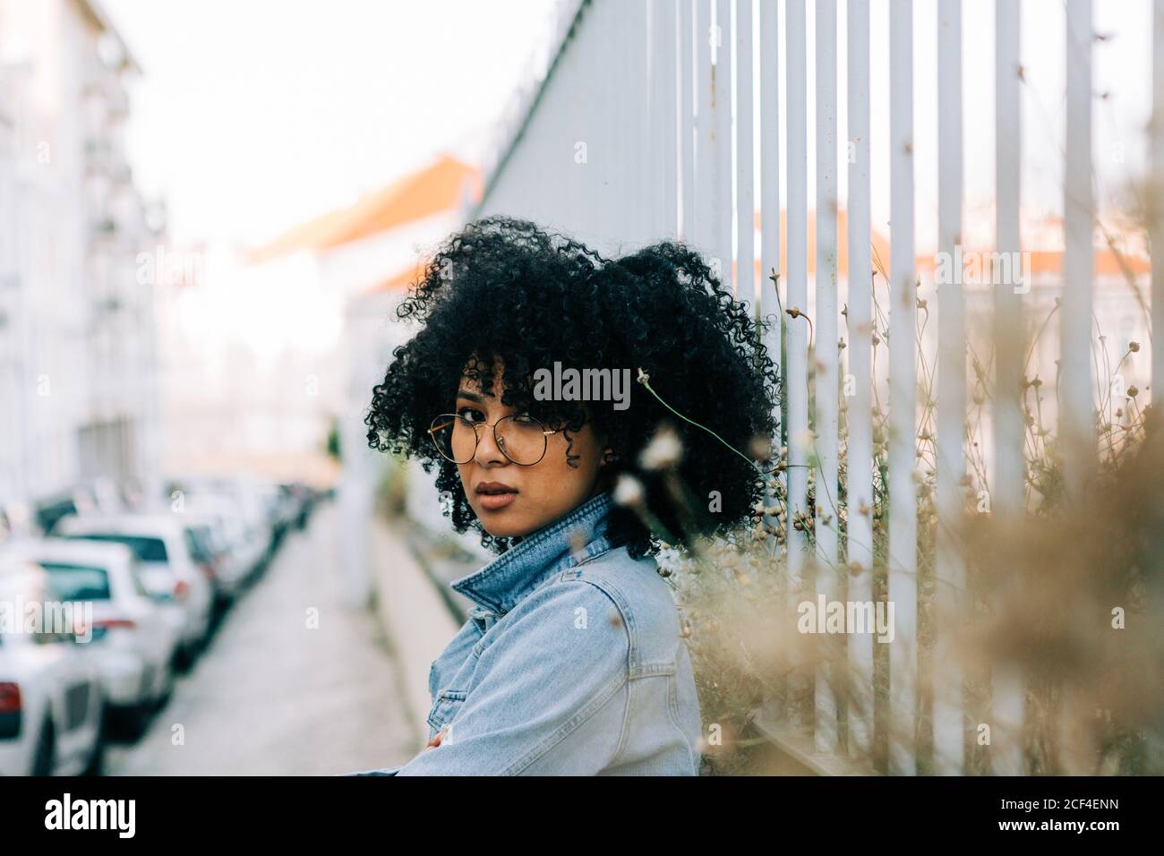 Side view of cheerful African American Woman in denim jacket standing ...