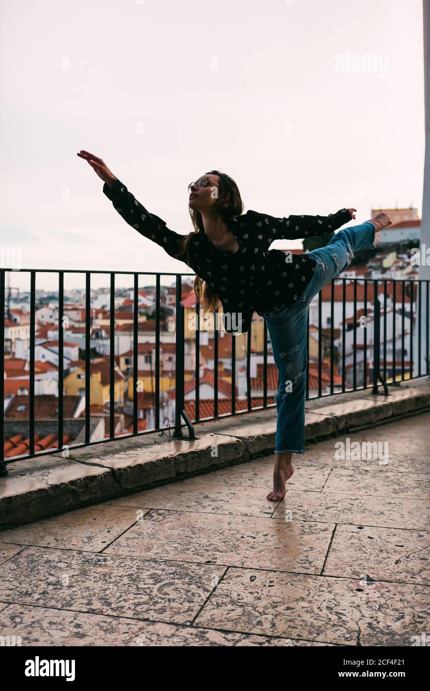 back view of casual teen Woman in splits while dancing beautifully on ...