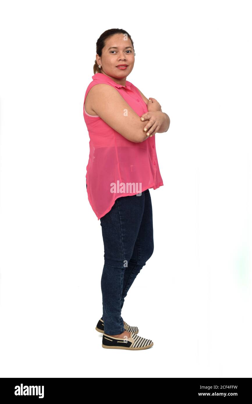full portrait of woman standing and side view and looking at camera white background, arms ...