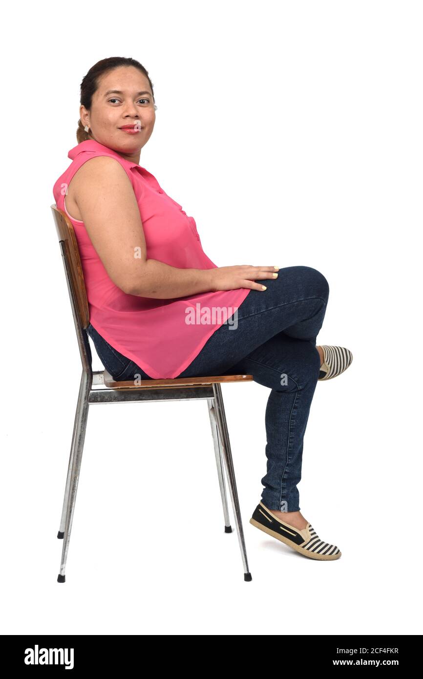 portrait of a woman sitting on a chair with the body in profile and ...