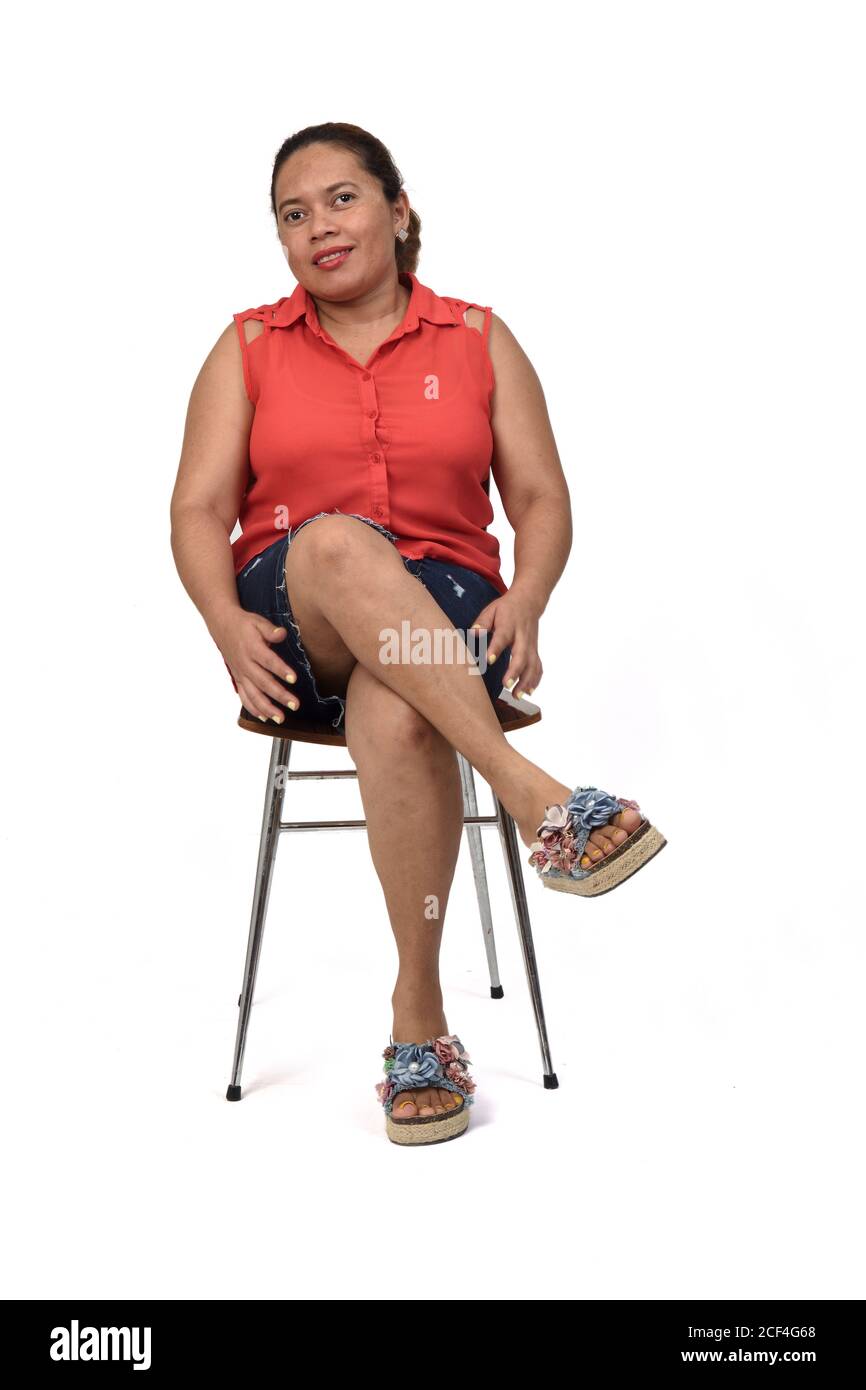 front view a woman sitting on a chair and looking at the camera on ...