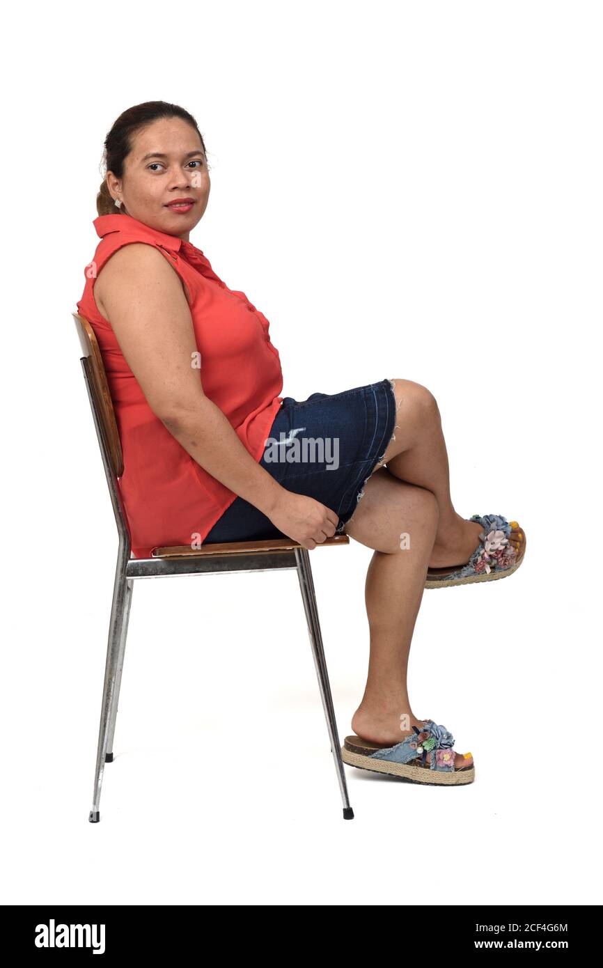 Woman crossed legs sitting skirt Cut Out Stock Images & Pictures - Alamy