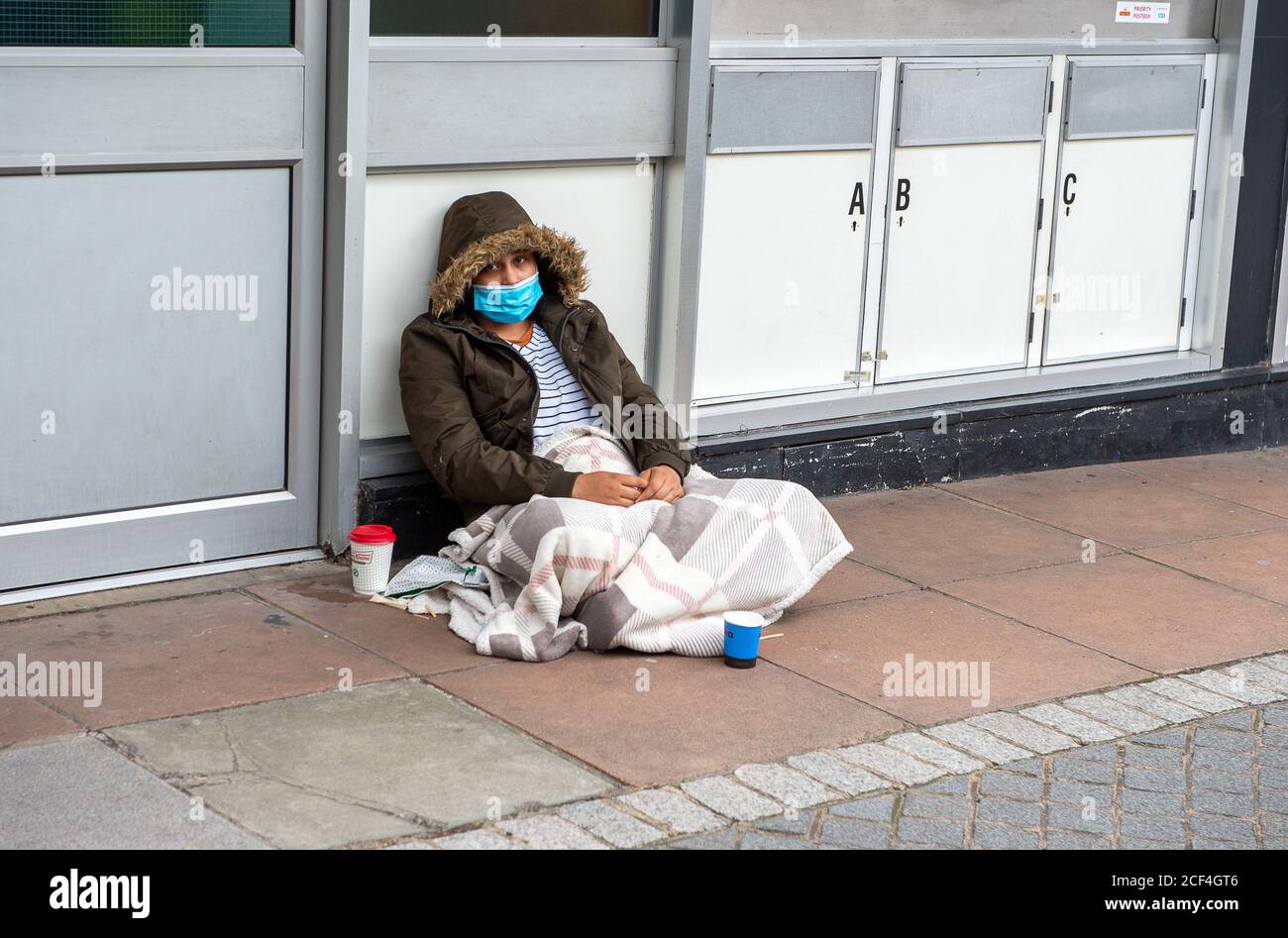 Wearing begging cup hi-res stock photography and images - Alamy