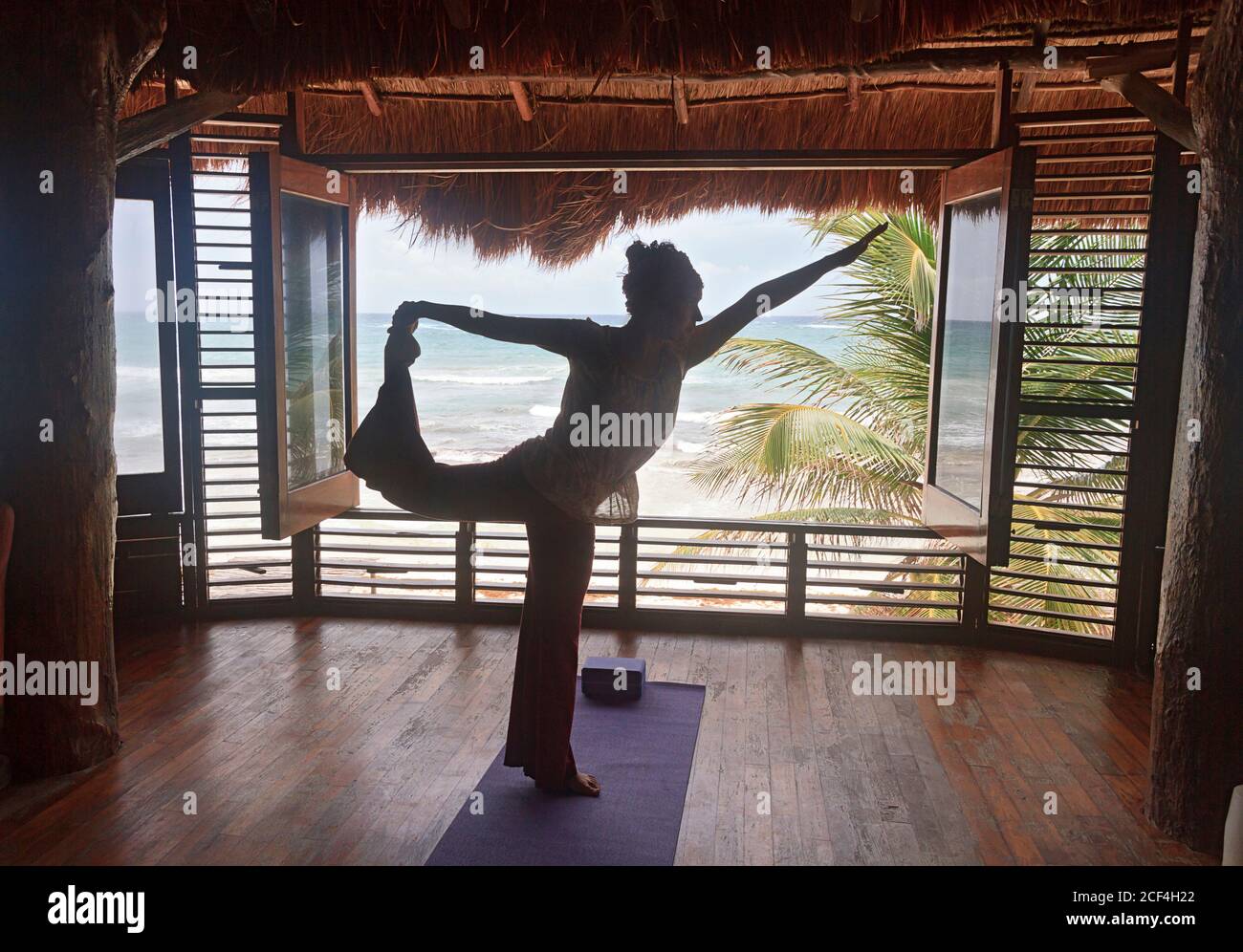 Woman does 'damcer' yoga pose at a beachside resort in Riviera Maya ...