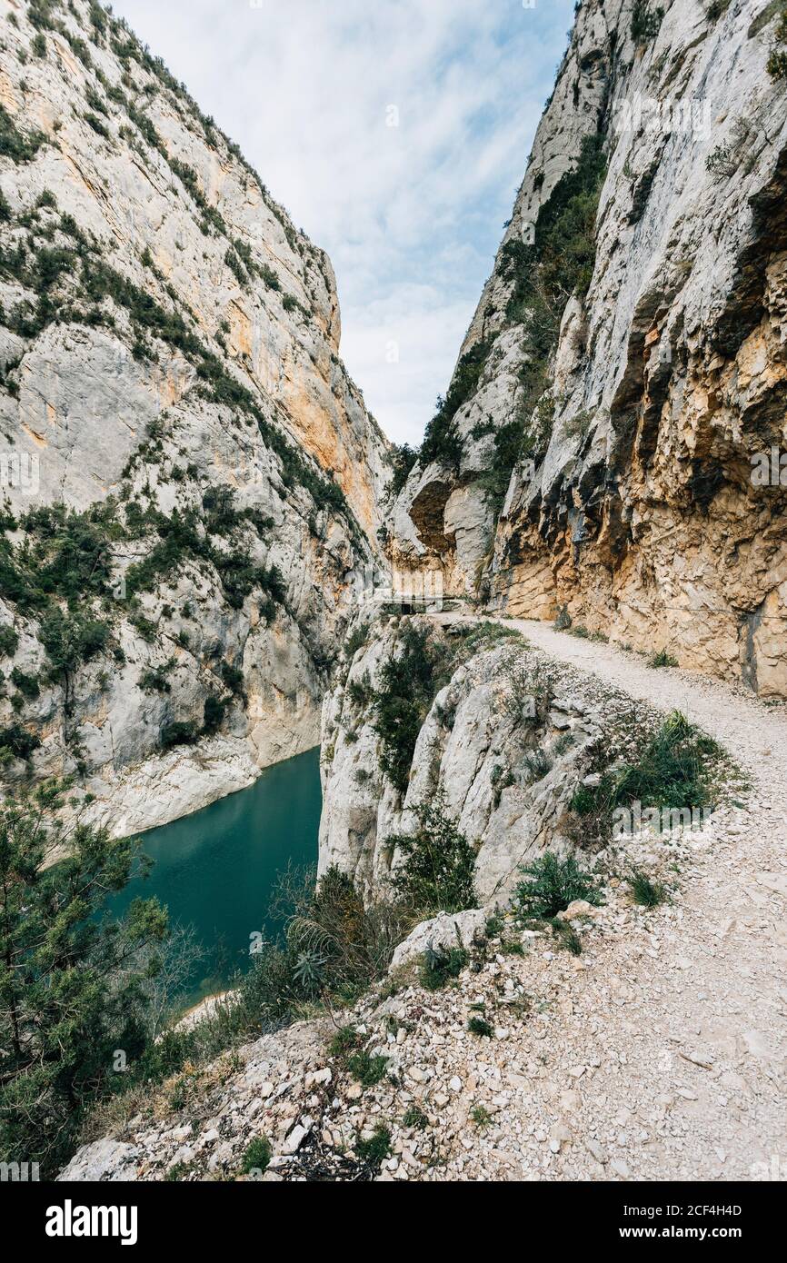 Spectacular scenery of calm narrow river with green water flowing among ...