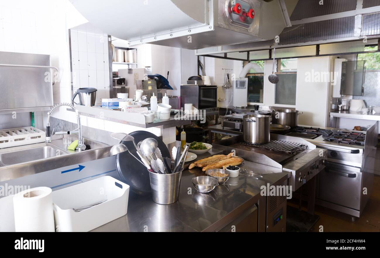 View of empty restaurant kitchen with professional equipment and ...