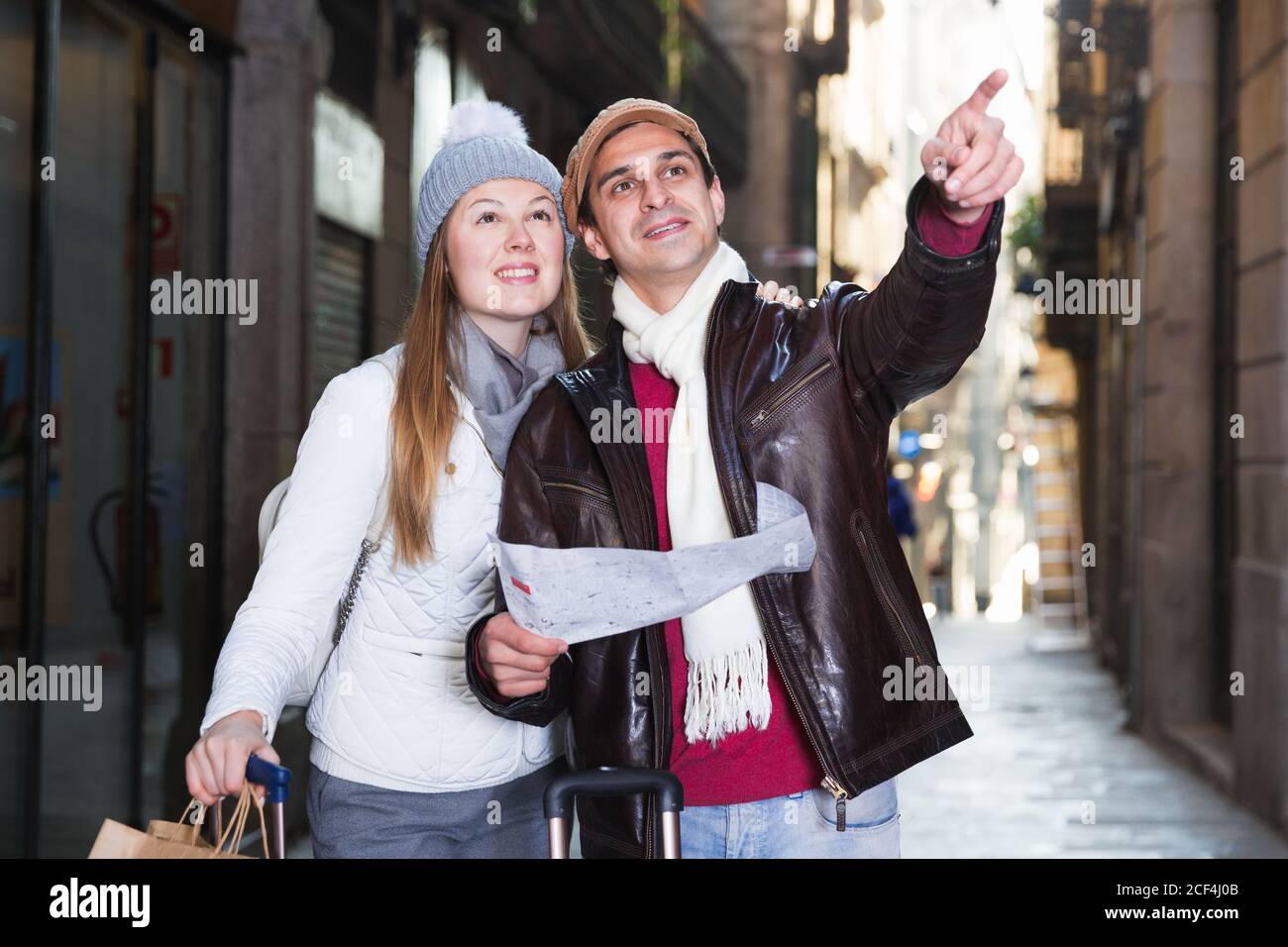 Portrait of adult tourists standing with map at street in hats Stock ...