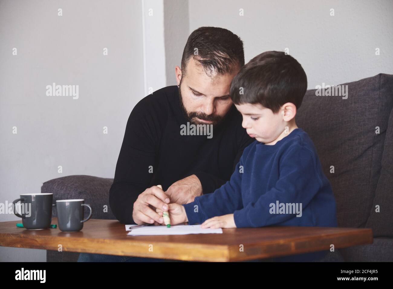 Man helping boy hi-res stock photography and images - Alamy
