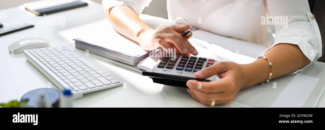 Lady Calculating Invoice. Chartered Accountant With Calculator Stock ...