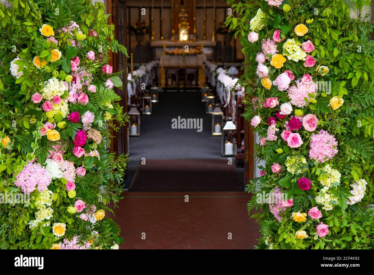 Interior of a catholic church, beautifully decorated with flowers for a ...