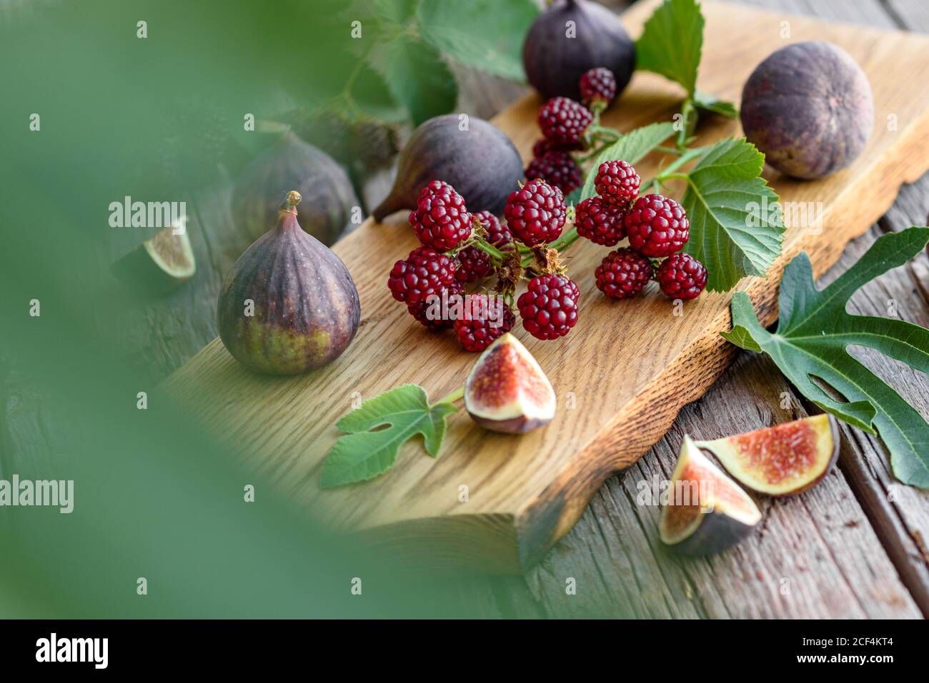 Fresh juicy figs and blackberries on a dark background. Harvesting ...