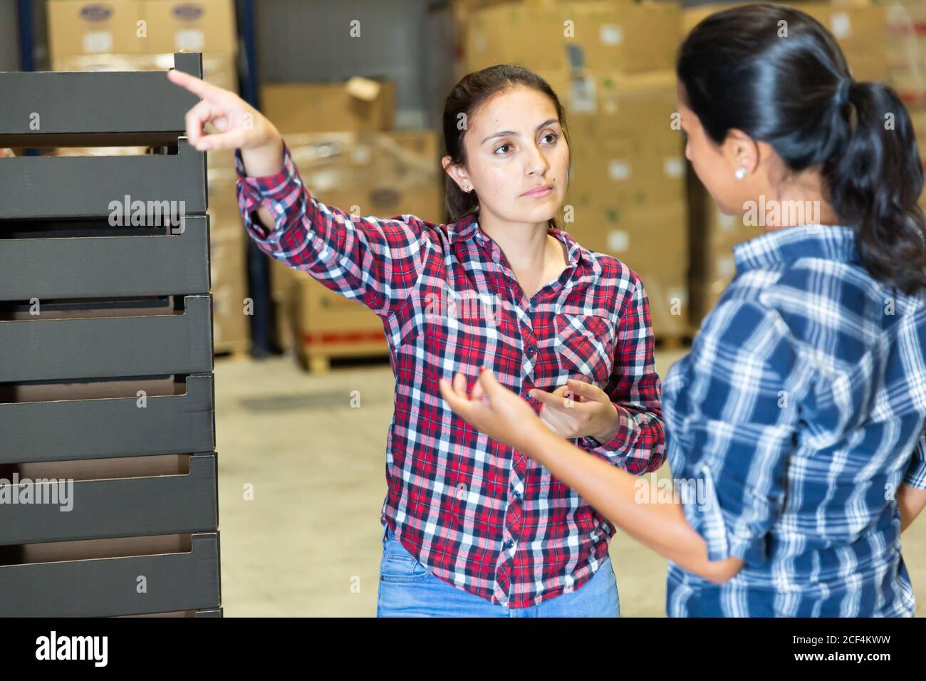 Portrait of factory warehouse manager instructs hired worker Stock ...