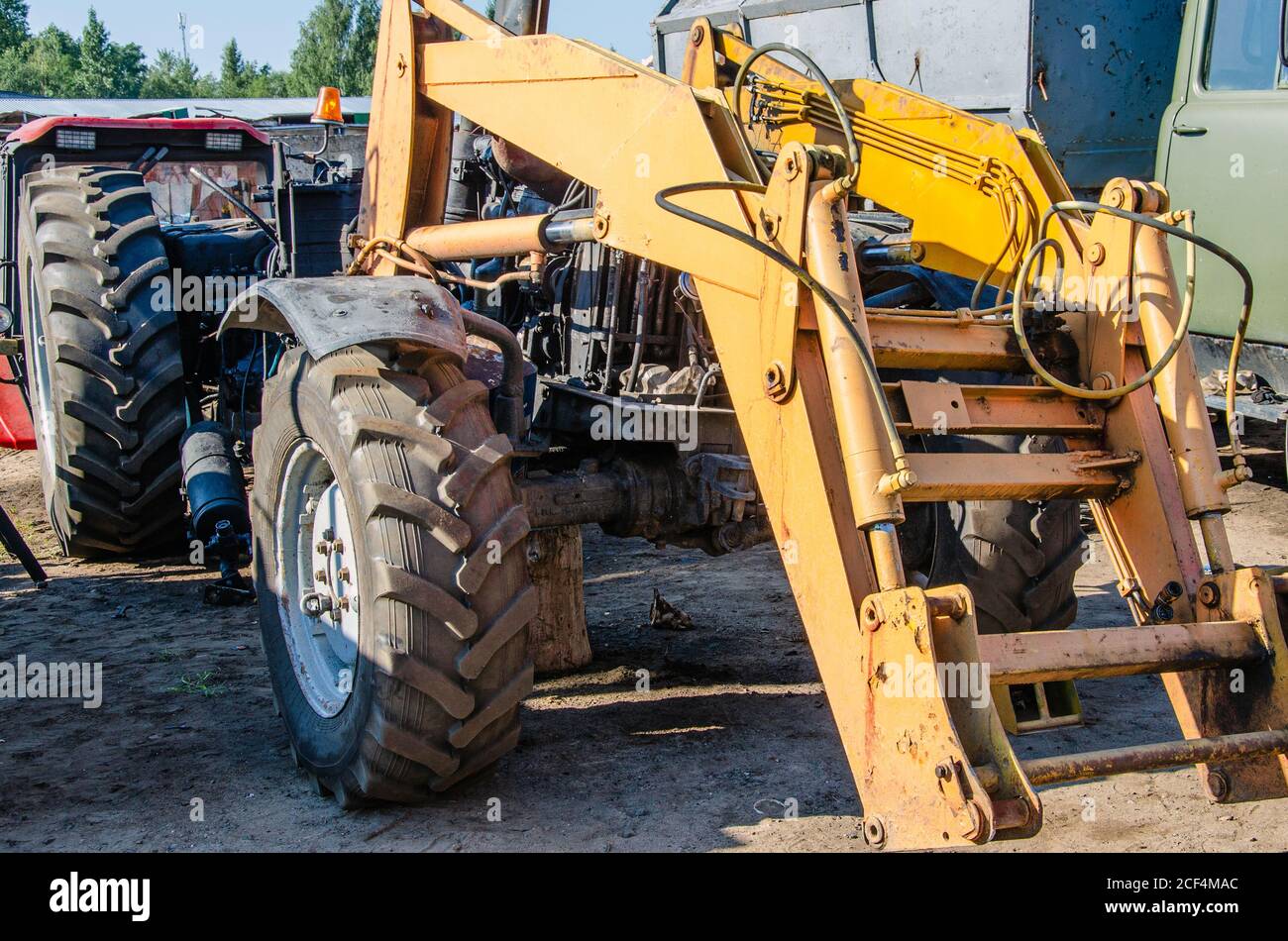 Old rusty tractor's flat back tire. industrial Stock Photo - Alamy