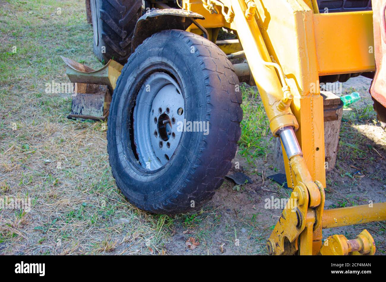 Old rusty tractor's flat back tire. industrial Stock Photo - Alamy