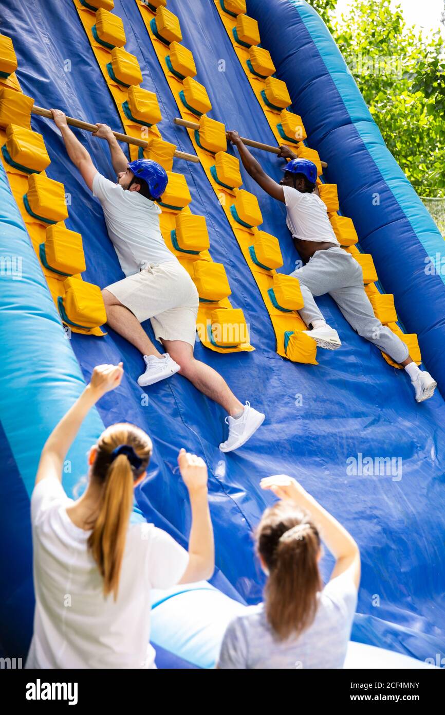 Inflatable slide Great race - climbing with a stick on an inflatable ...
