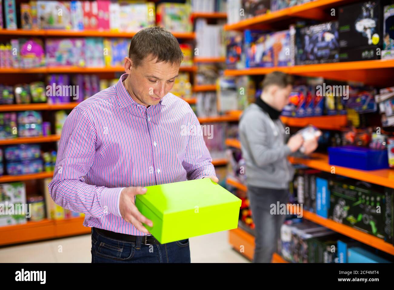 Father and children in toy store hi-res stock photography and images ...