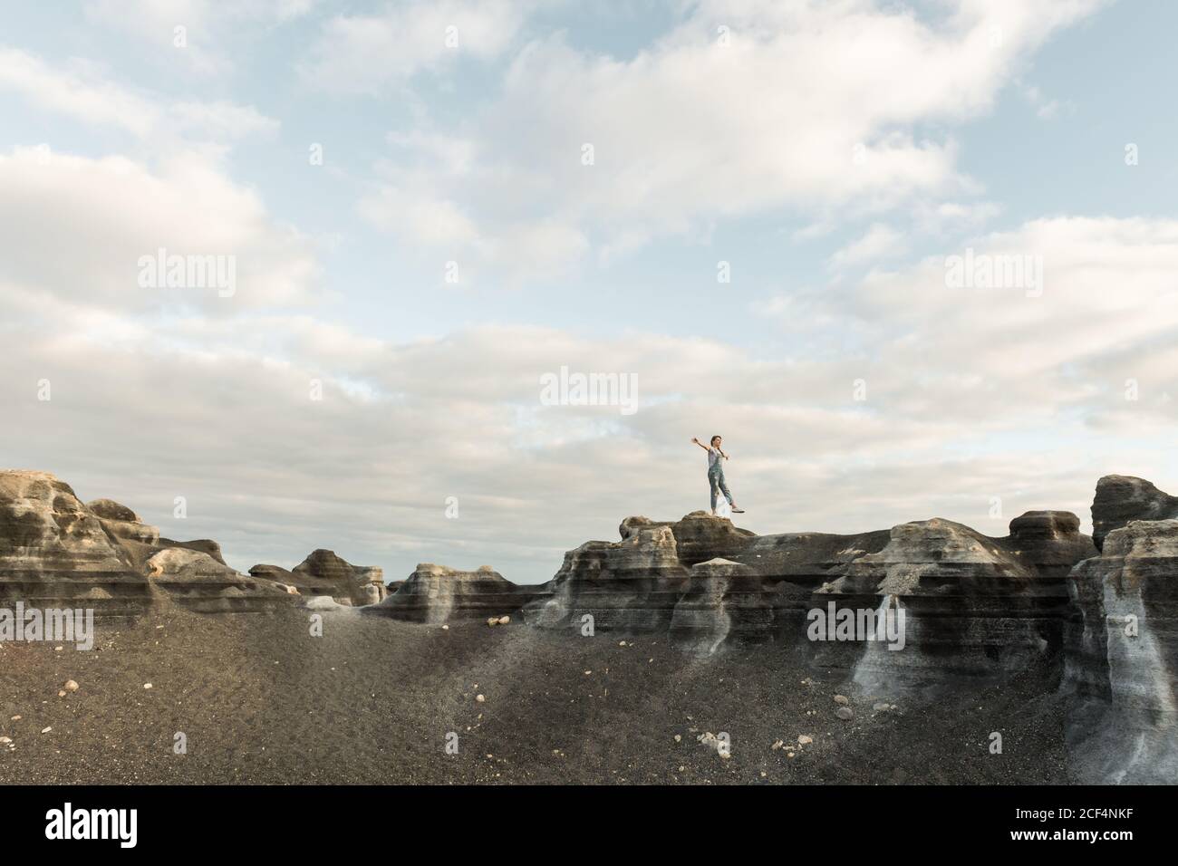 anonymous female standing of stony terrain Stock Photo - Alamy