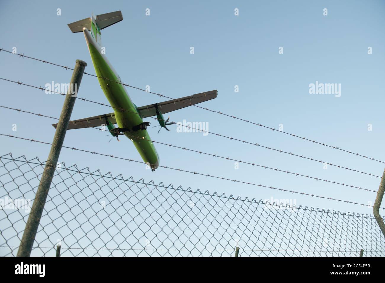 Plane behind security fence Stock Photo - Alamy