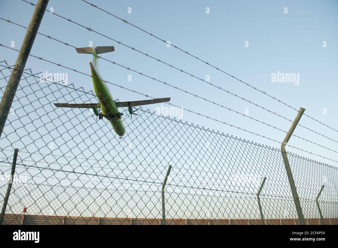 Plane behind security fence Stock Photo - Alamy