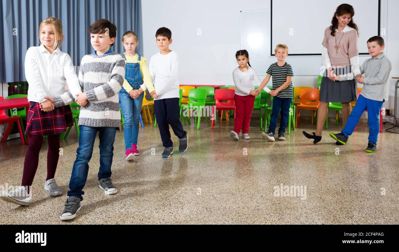 Happy laughing pupils of primary school having fun during break with ...