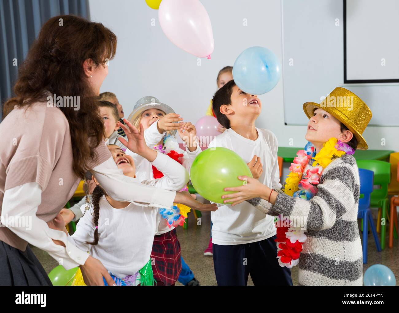 Happy laughing pupils of primary school having fun during festive event ...