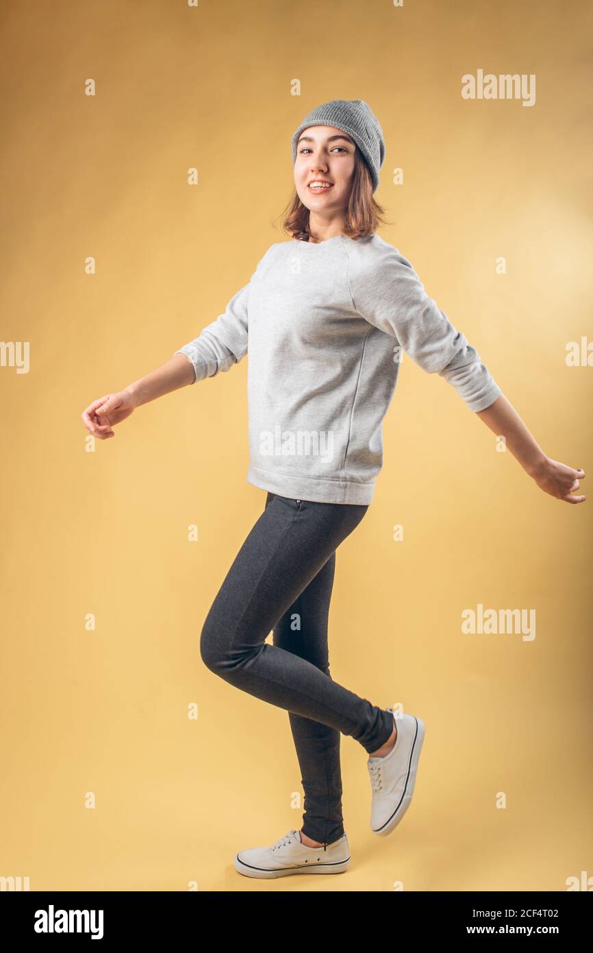 Happy beautiful girl dancing and celebrating standing in full length ...