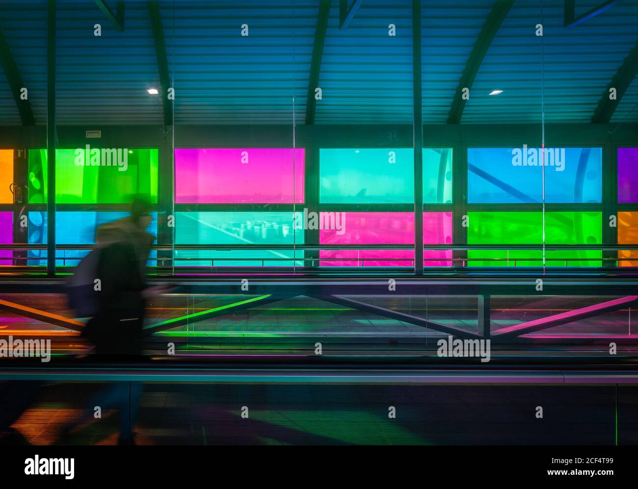 anonymous moved person with suitcase riding mowing walkway near ...