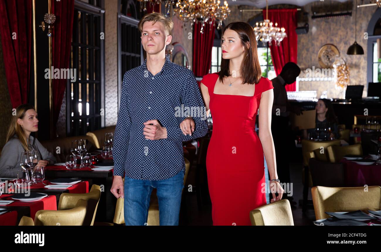Gentleman with elegant woman walks in luxury restaurant hall Stock ...