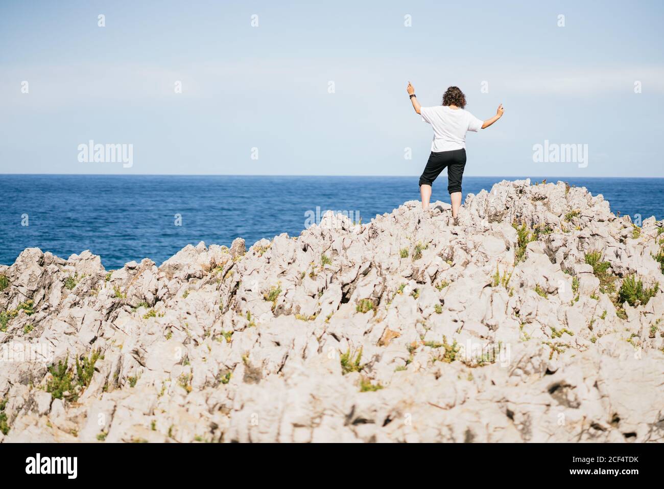 Woman standing hill arms hi-res stock photography and images - Alamy