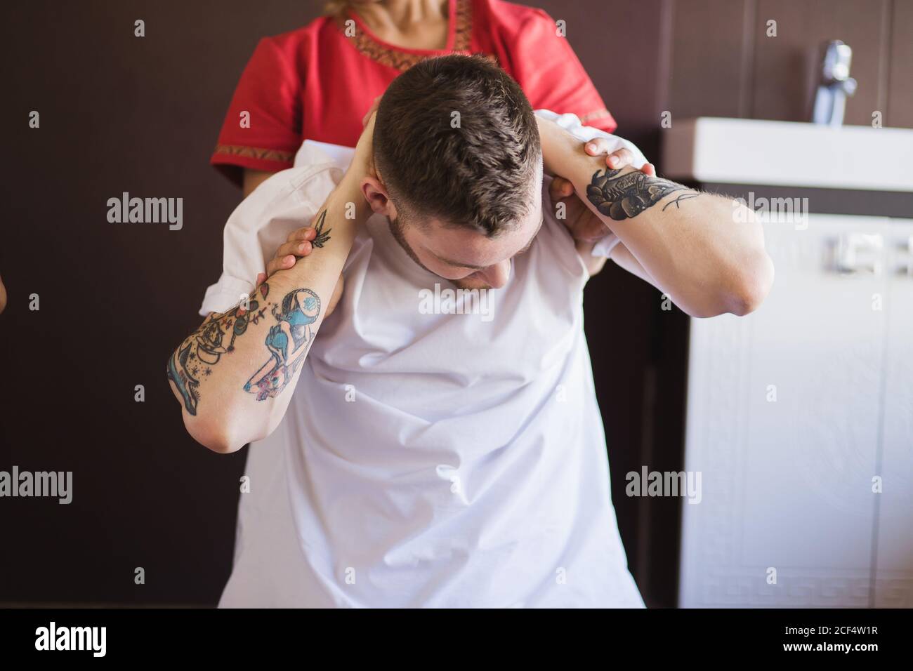 Thai masseur doing massage for european man in spa salon Stock Photo ...