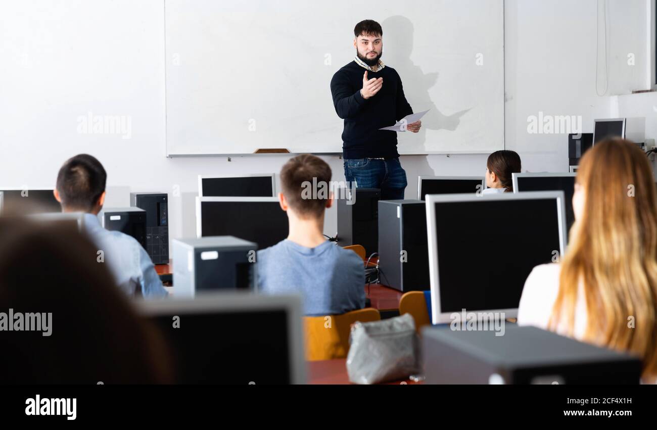 Positive male teacher lecturing hi-res stock photography and images - Alamy