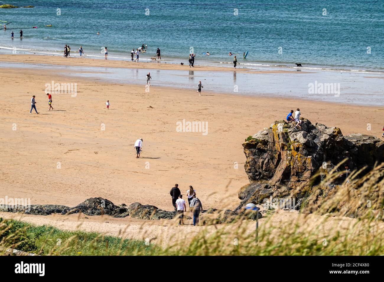 Holiday Makers on east beach and Yellow Craig Rock, Milsey Bay, North ...