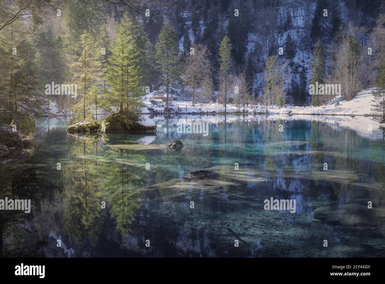 Landscape of peaceful azure lake with snowy shore in mountains of ...