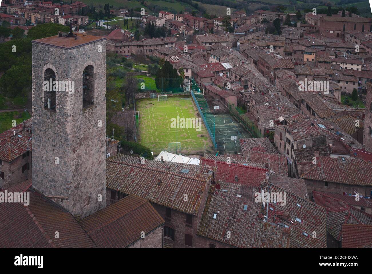 View at height of old stone buildings with football field, Italy Stock ...
