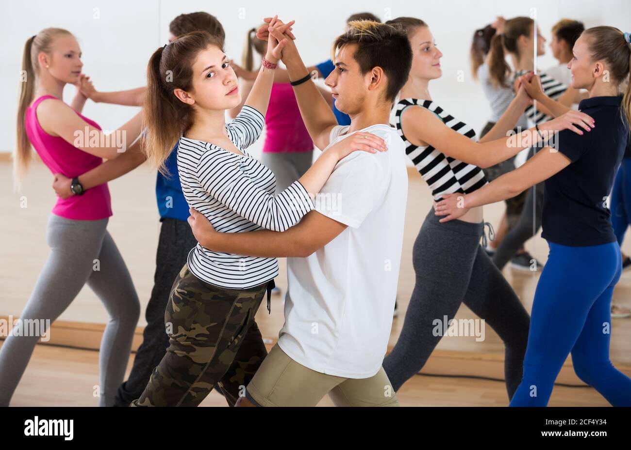 Group of positive french teen dancing salsa in dance studio Stock Photo ...