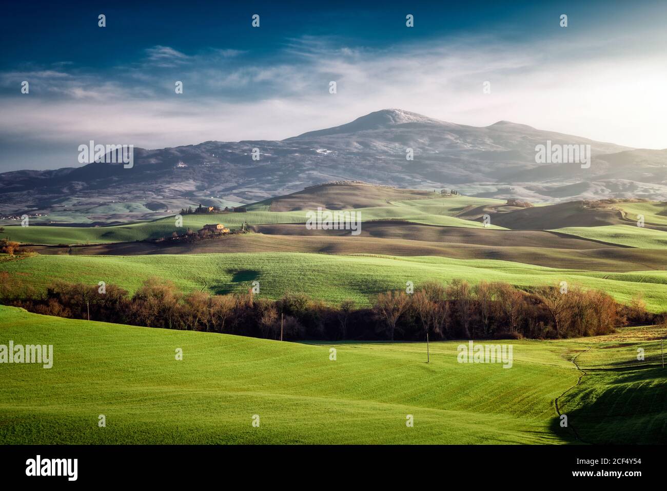 Panoramic view of beautiful endless green fields in bright sunlight ...