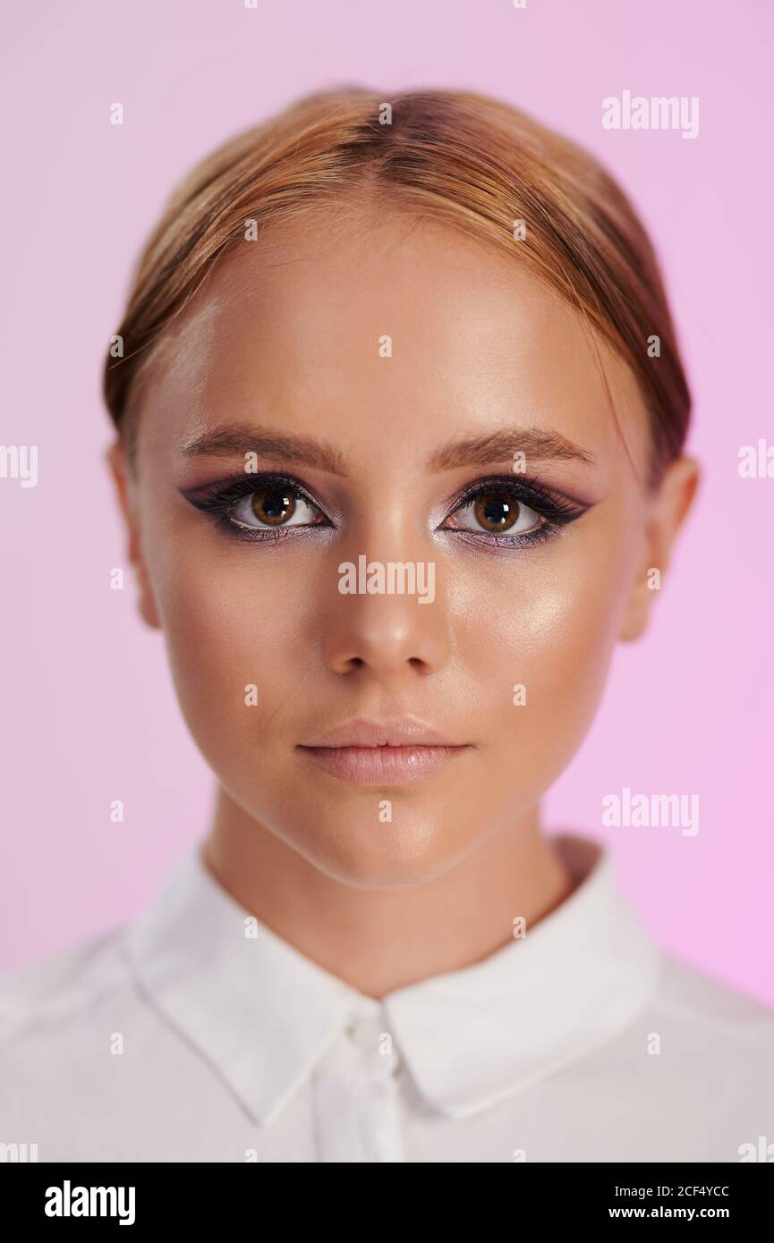 Serious looking young woman portrait isolated on pink background Stock ...