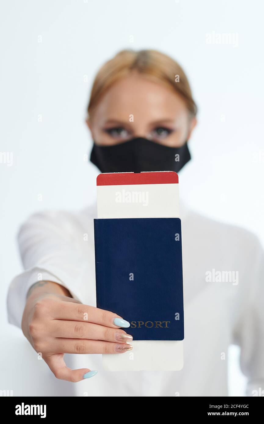 Passport with ticket pass in hand on blurred woman background Stock ...