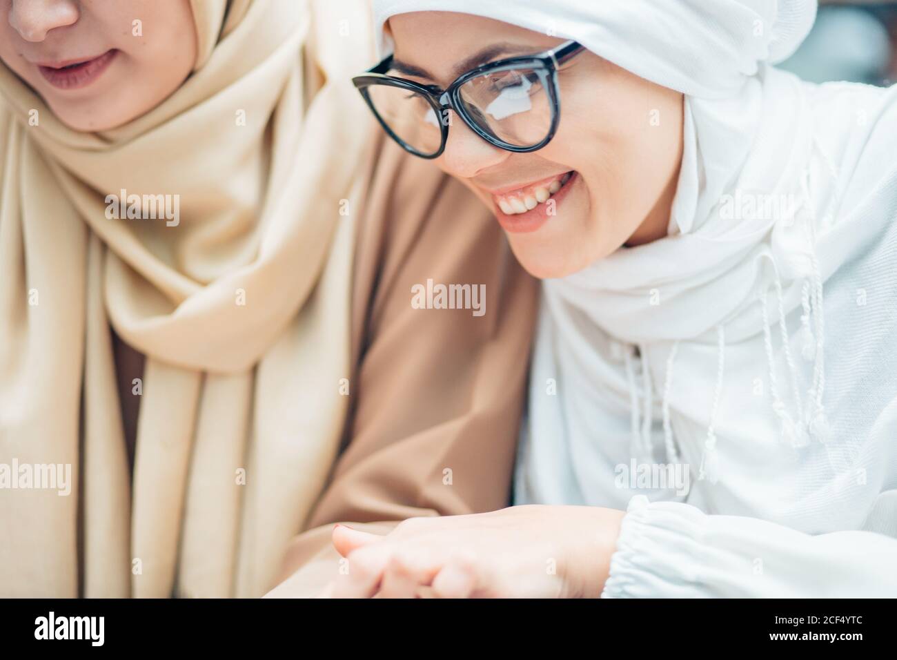 Two Muslim Friends Enjoying sitting in cafe Stock Photo - Alamy