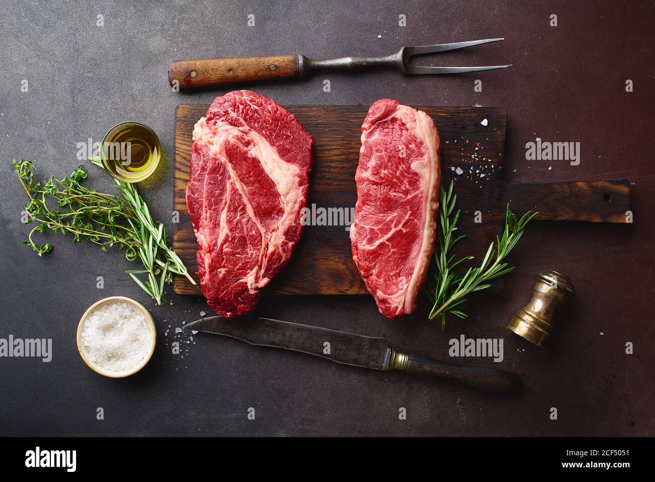Top view of raw black angus prime beef steaks on wooden cutting board ...