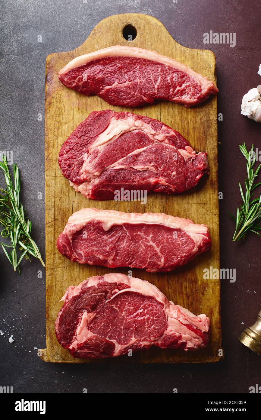 Top view of raw black angus prime beef steaks on wooden cutting board ...