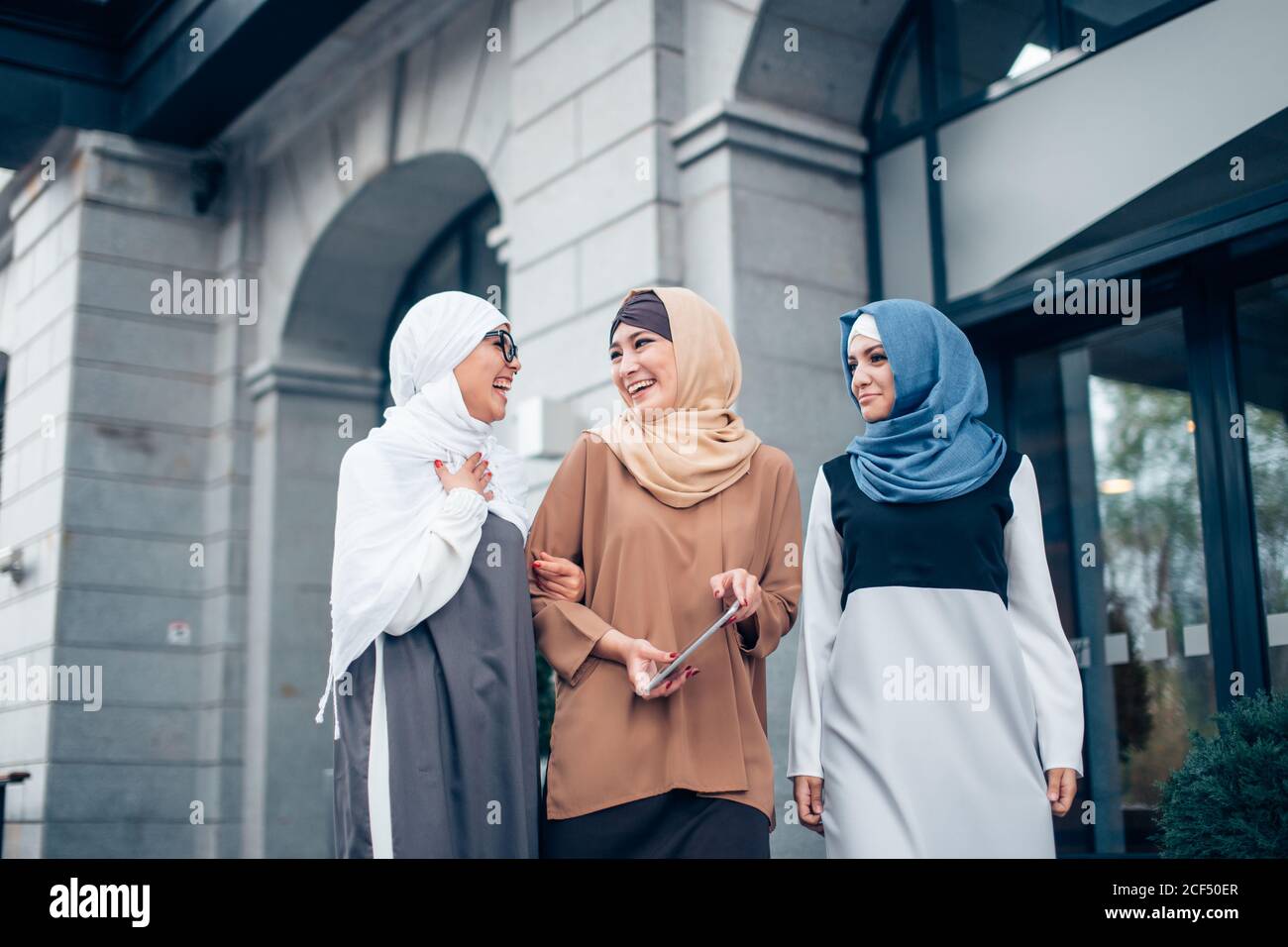 Three Muslim Female Friends Walking In City Stock Photo - Alamy