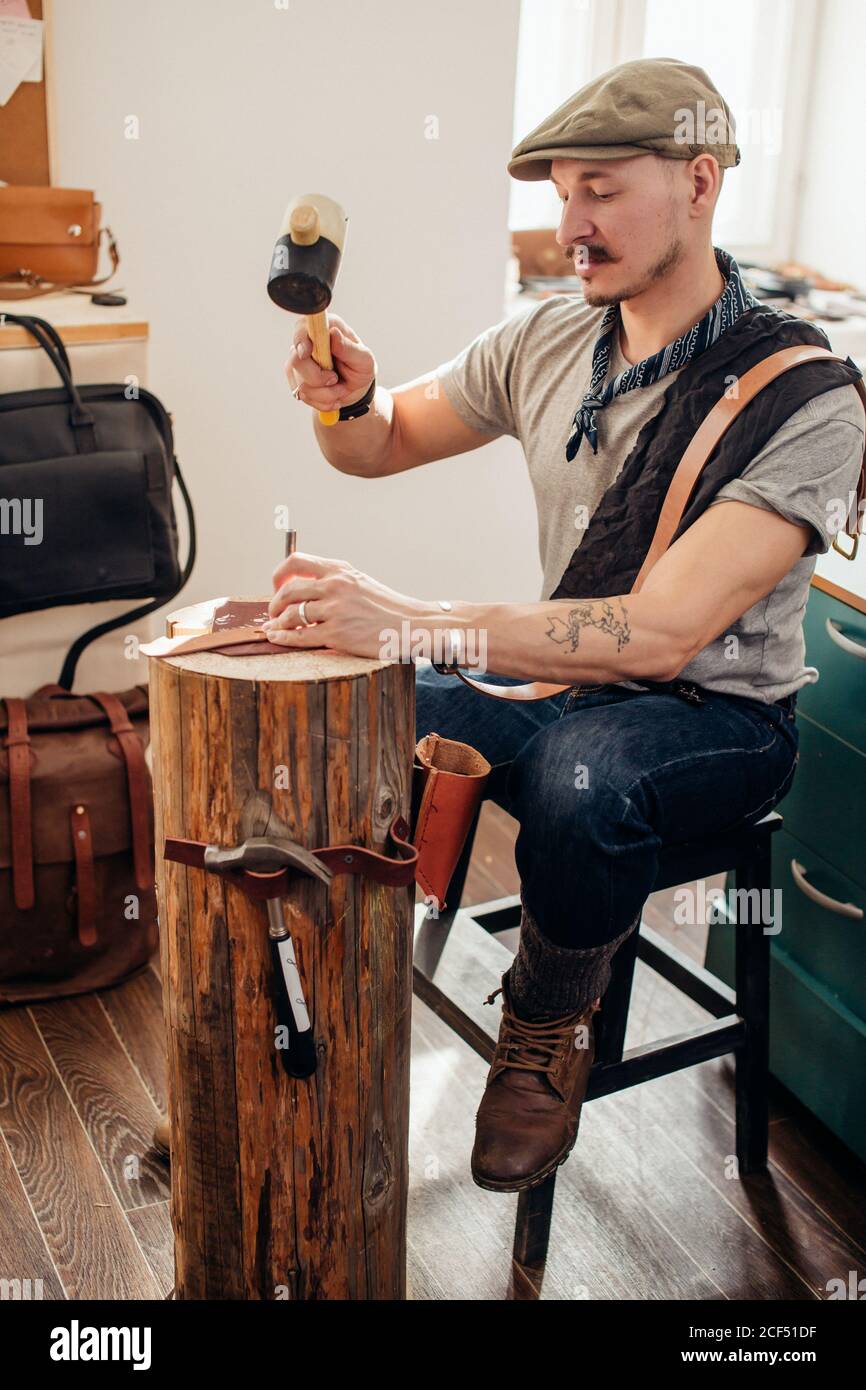 Professional crafter making leather items Stock Photo - Alamy