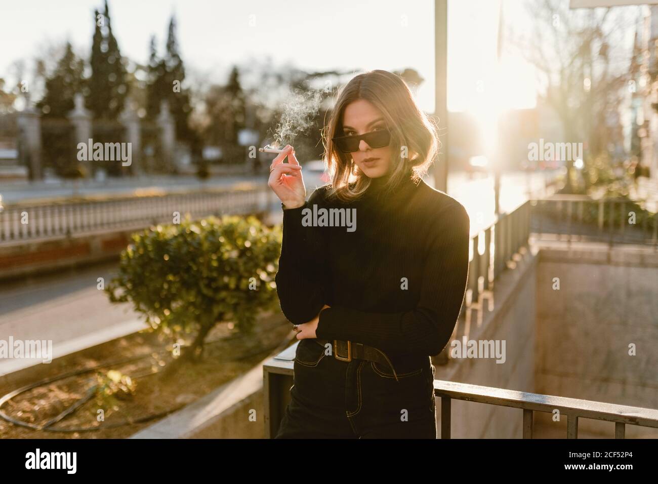 Beautiful young woman lighting cigarette hi-res stock photography and ...