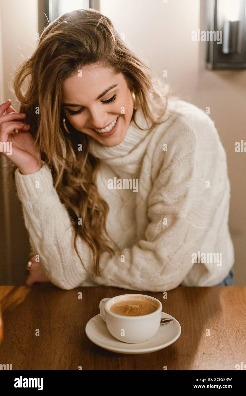 Elegant Woman mixing coffee in cafe Stock Photo - Alamy