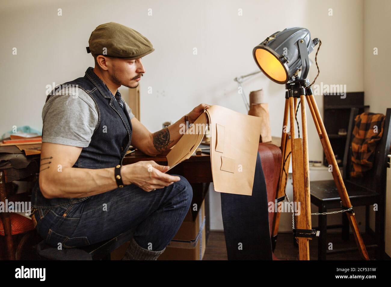 Professional crafter making leather items Stock Photo - Alamy