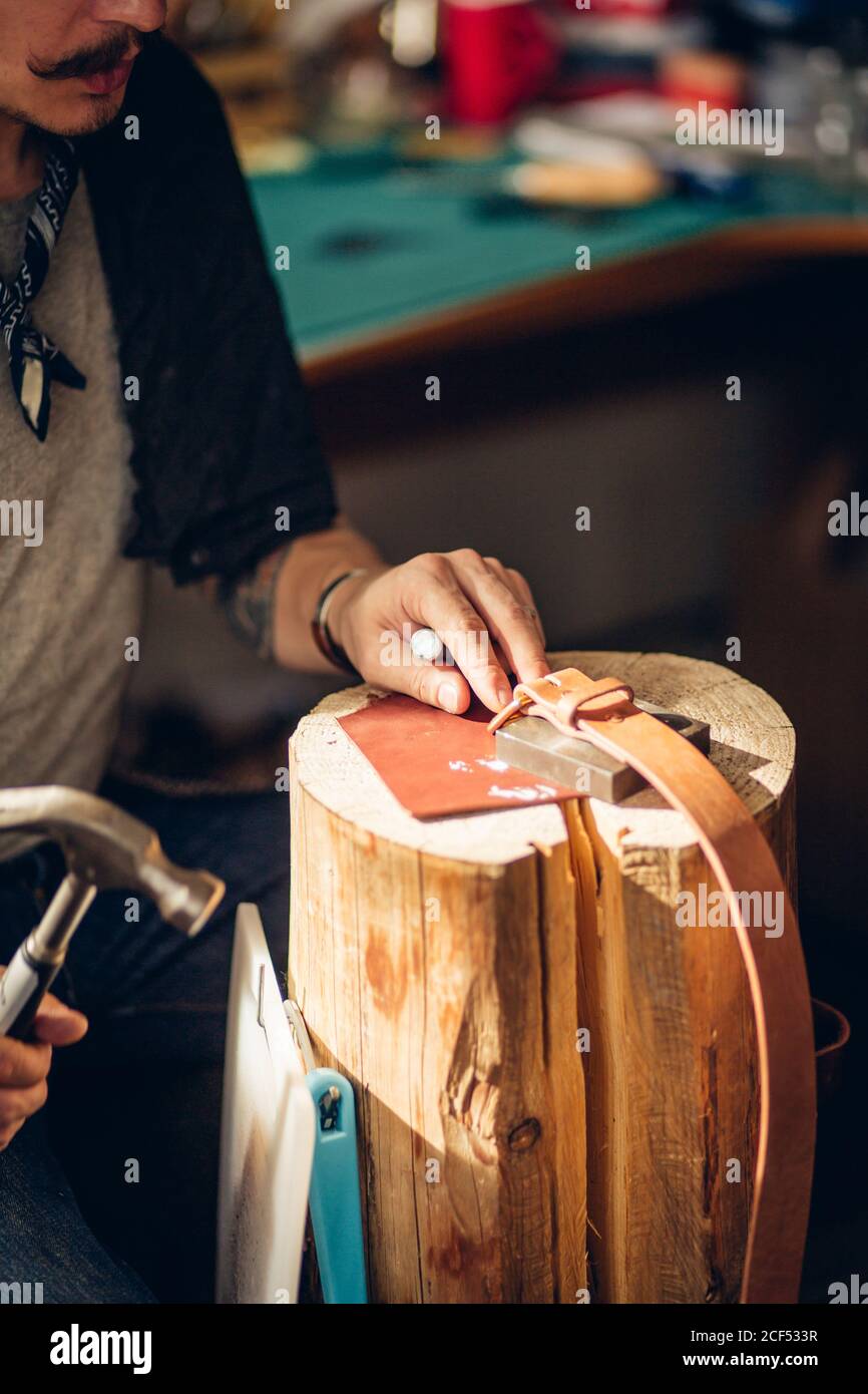 caucasian leather craft mustache man wearing cup working as artisan in ...