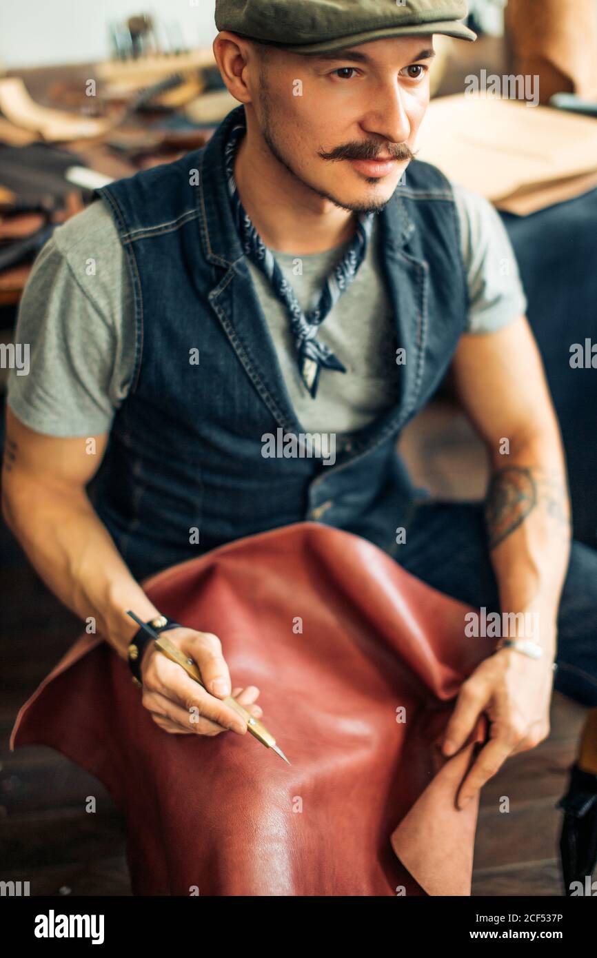 Professional crafter making leather items Stock Photo - Alamy