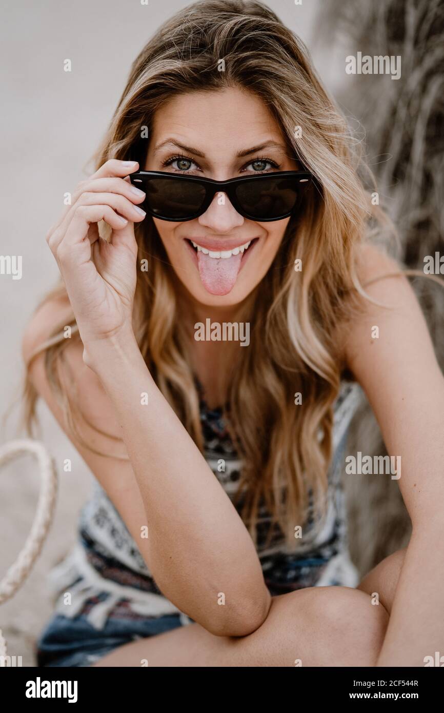 Close Up Portrait Of Pretty Blonde Woman In Black Sunglasses Sitting On